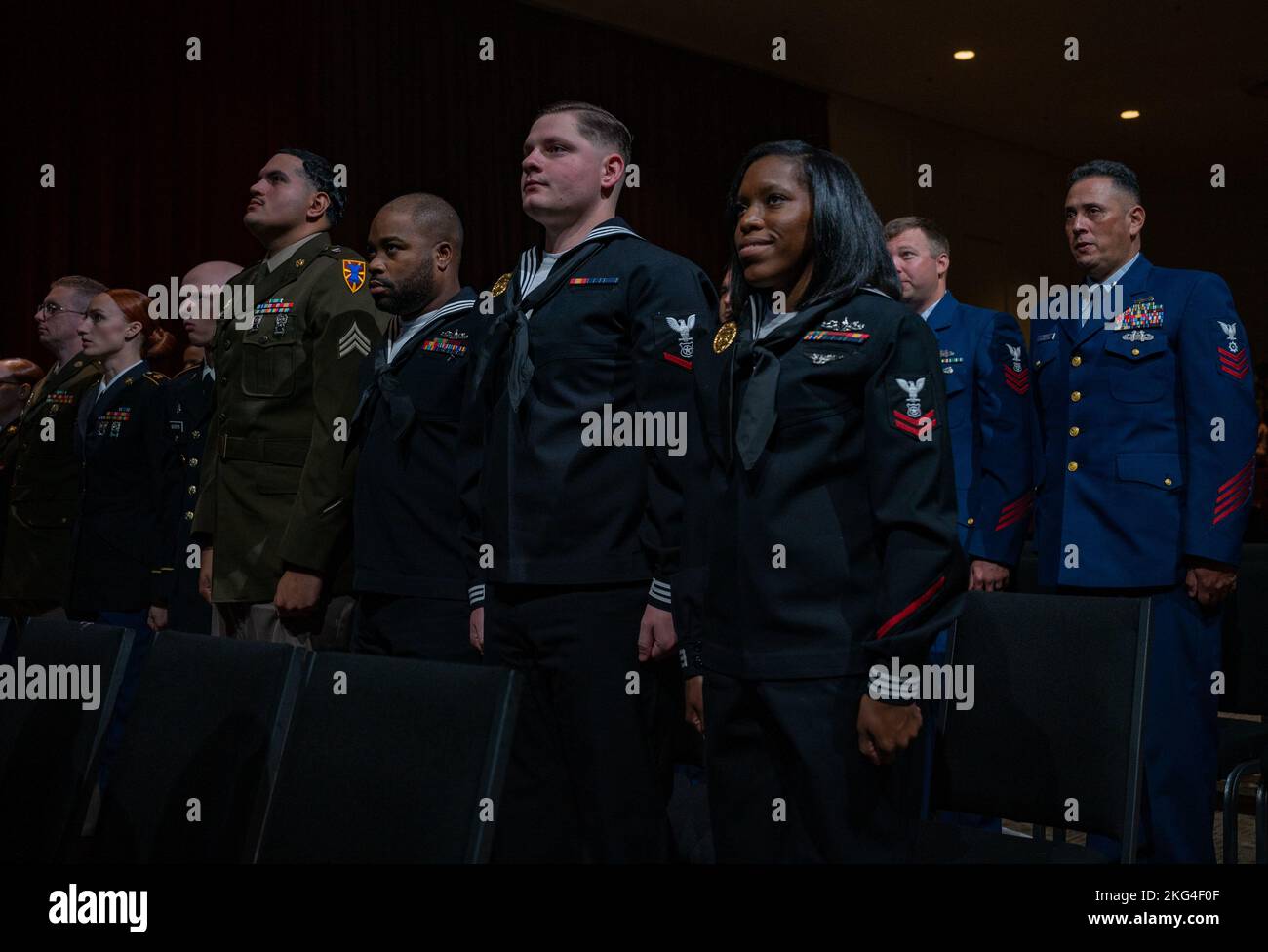 Service members stand at attention before reciting their respective ...