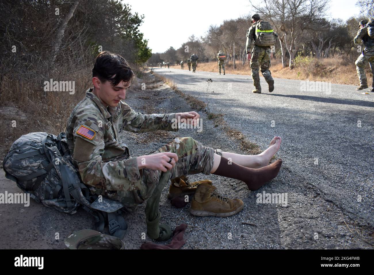 A Soldier performs preventative maintenance on his feet before ...