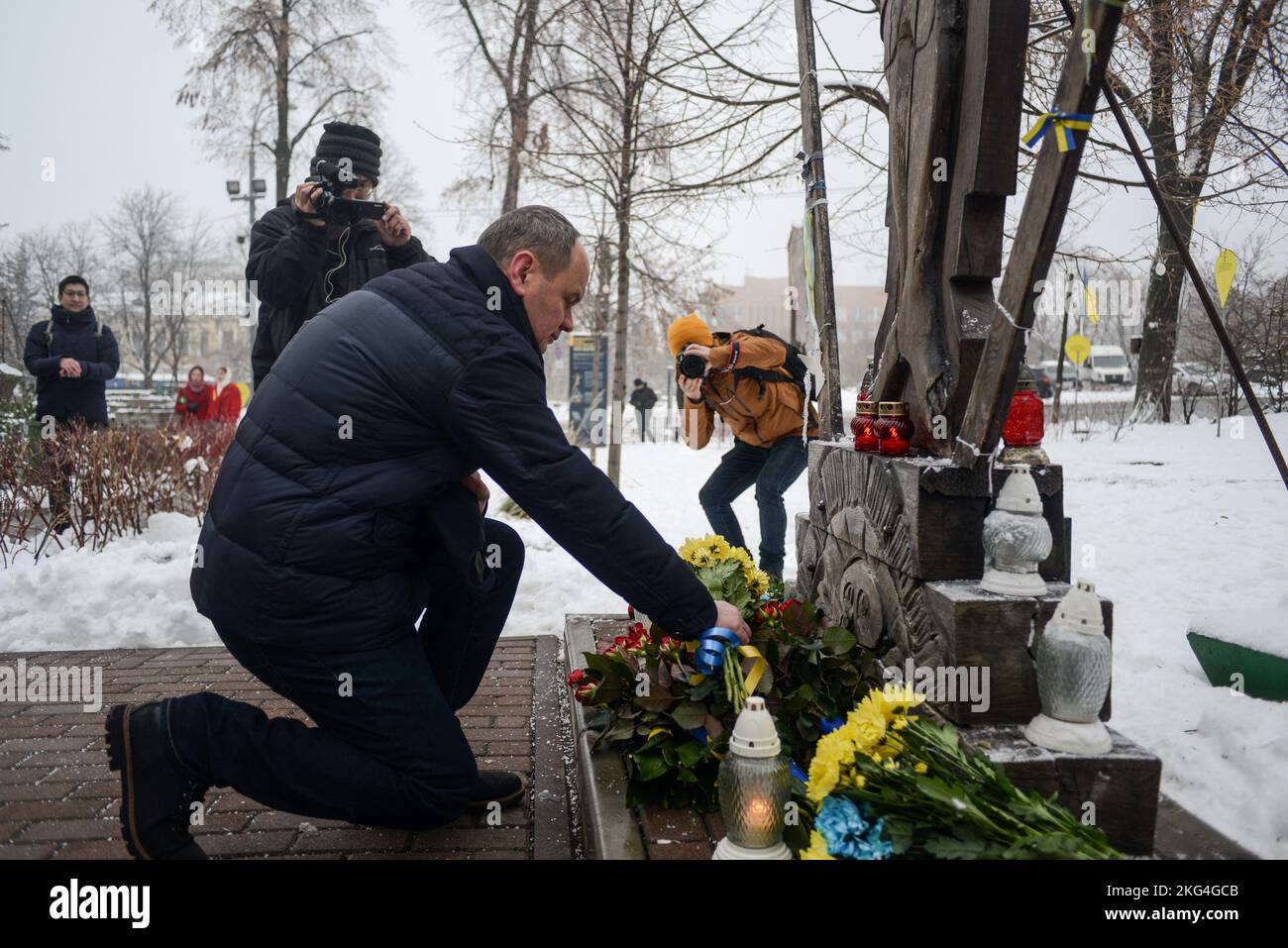 KYIV, UKRAINE - NOVEMBER 21, 2022 - A man lays flowers at the ...
