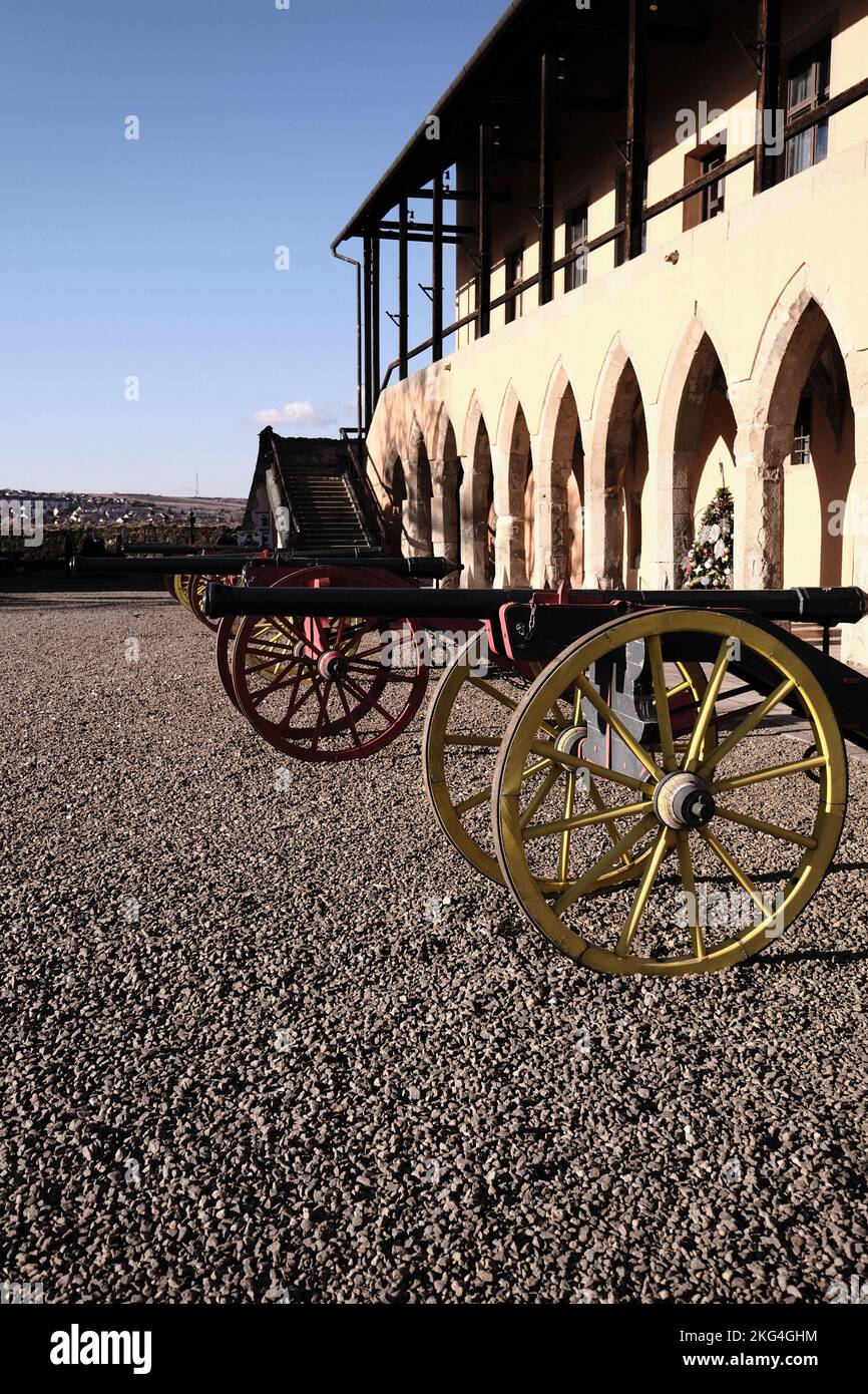 A vertical shot of machine guns on wheels on a rocky ground Stock Photo ...