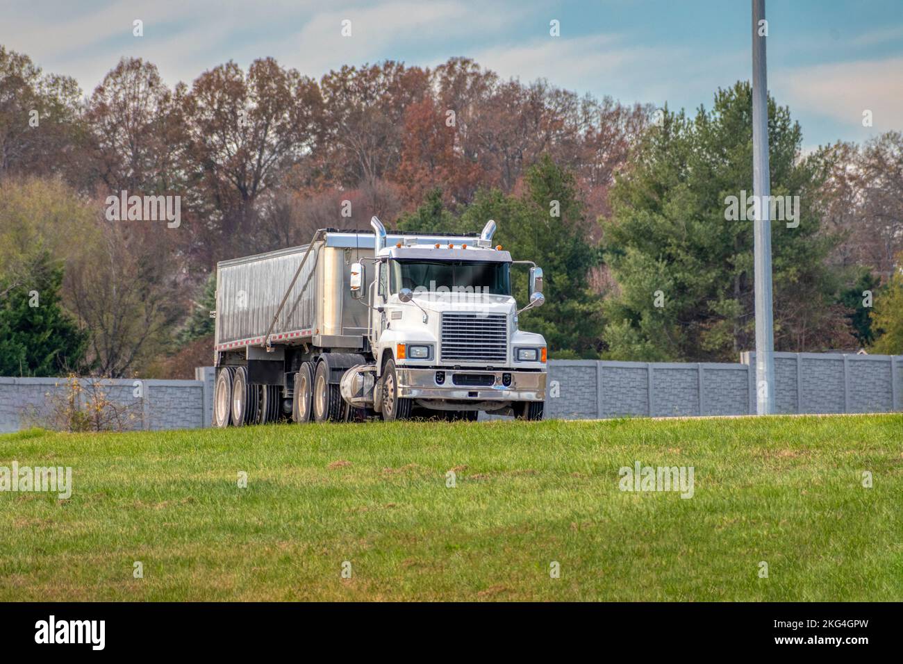 Horizontal shot of a commercial heavy dump truck exiting the highway ...