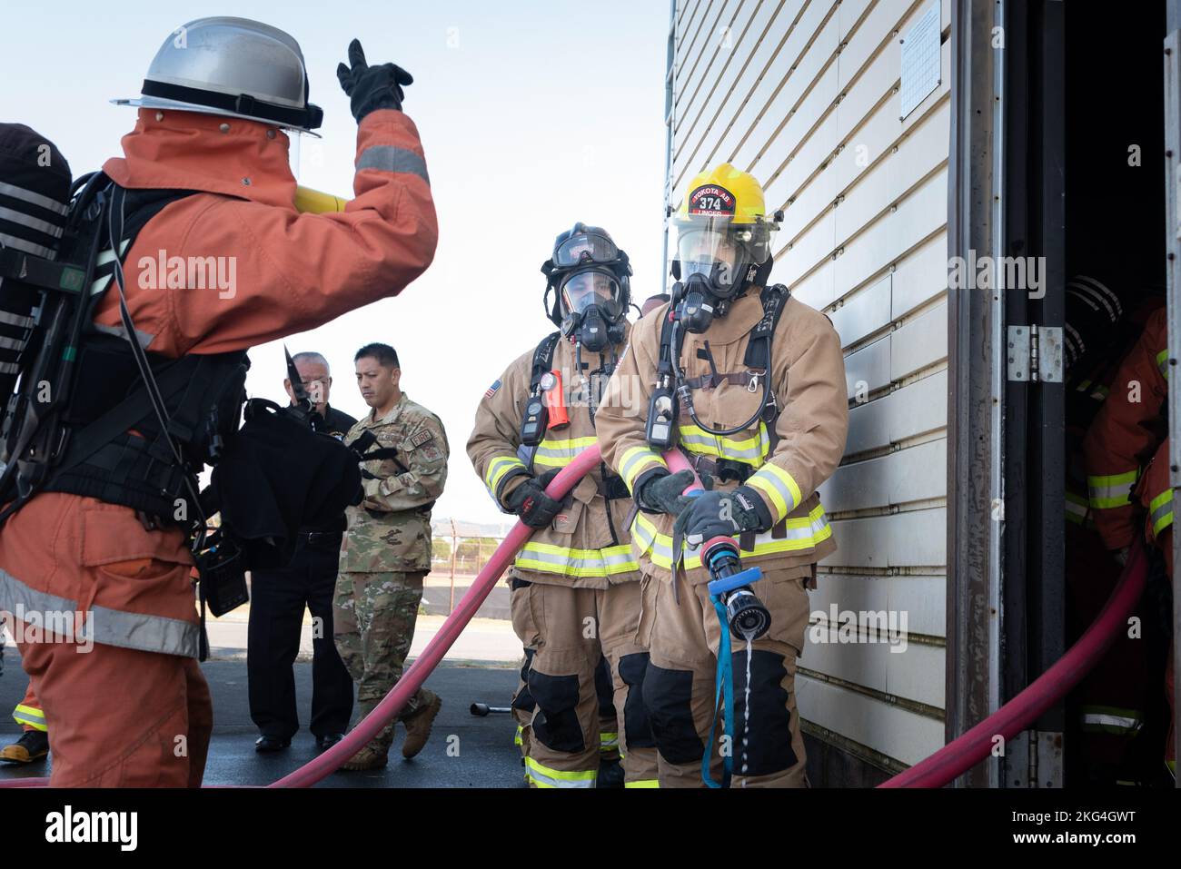 A firefighter with the Japanese Air Self-Defense Force, left ...