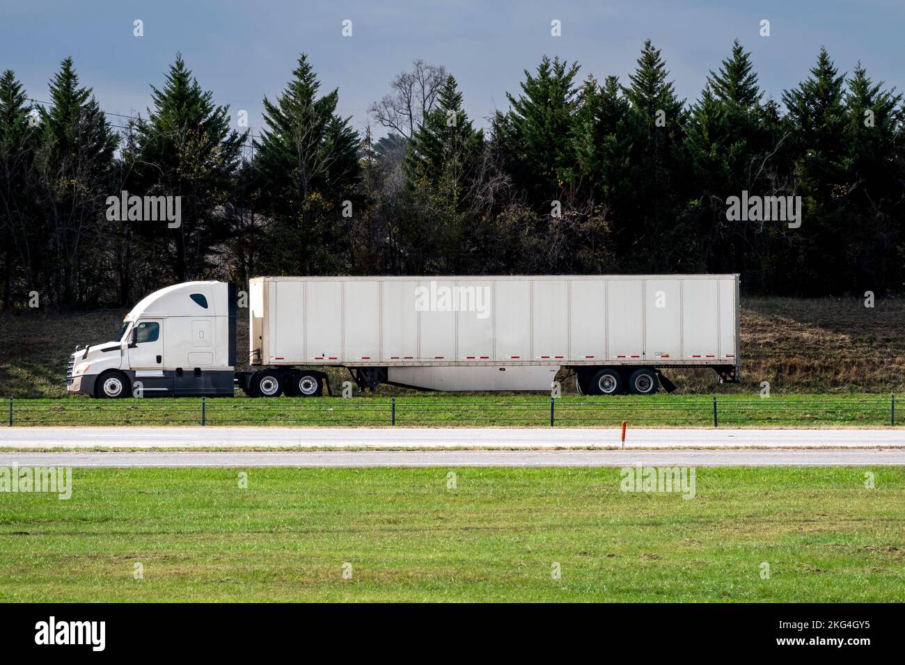 Horizontal shot of a blank white truck on the highway with copy space ...