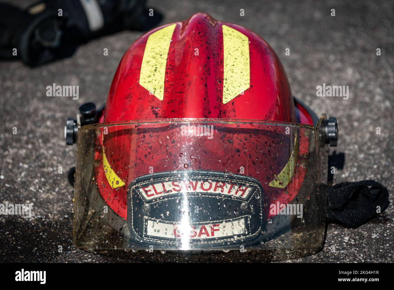 A 374th Civil Engineer Squadron firefighter helmet sits on the ground ...