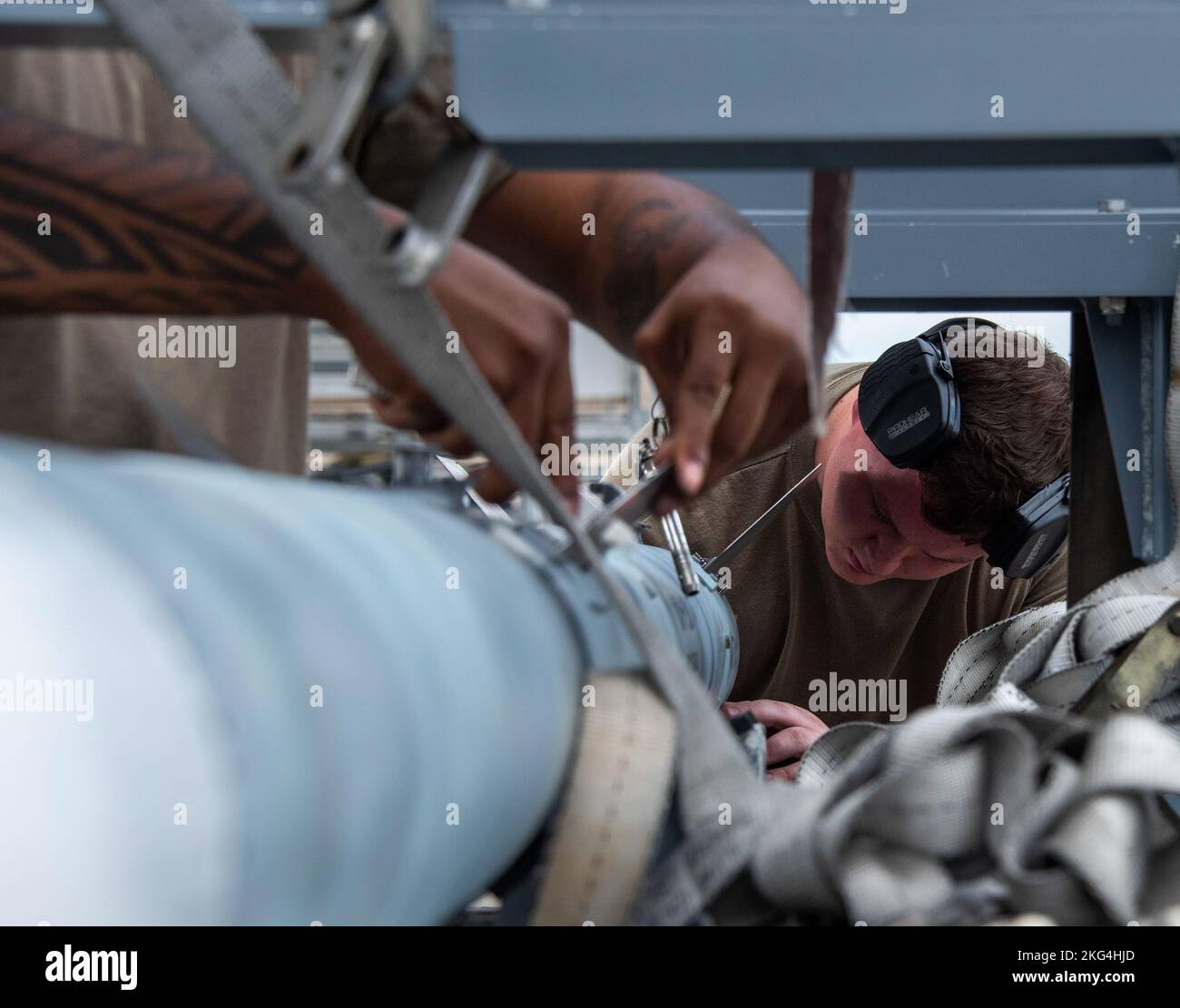 A 43rd Fighter Generation Squadron weapons load secures AIM-120 fins ...