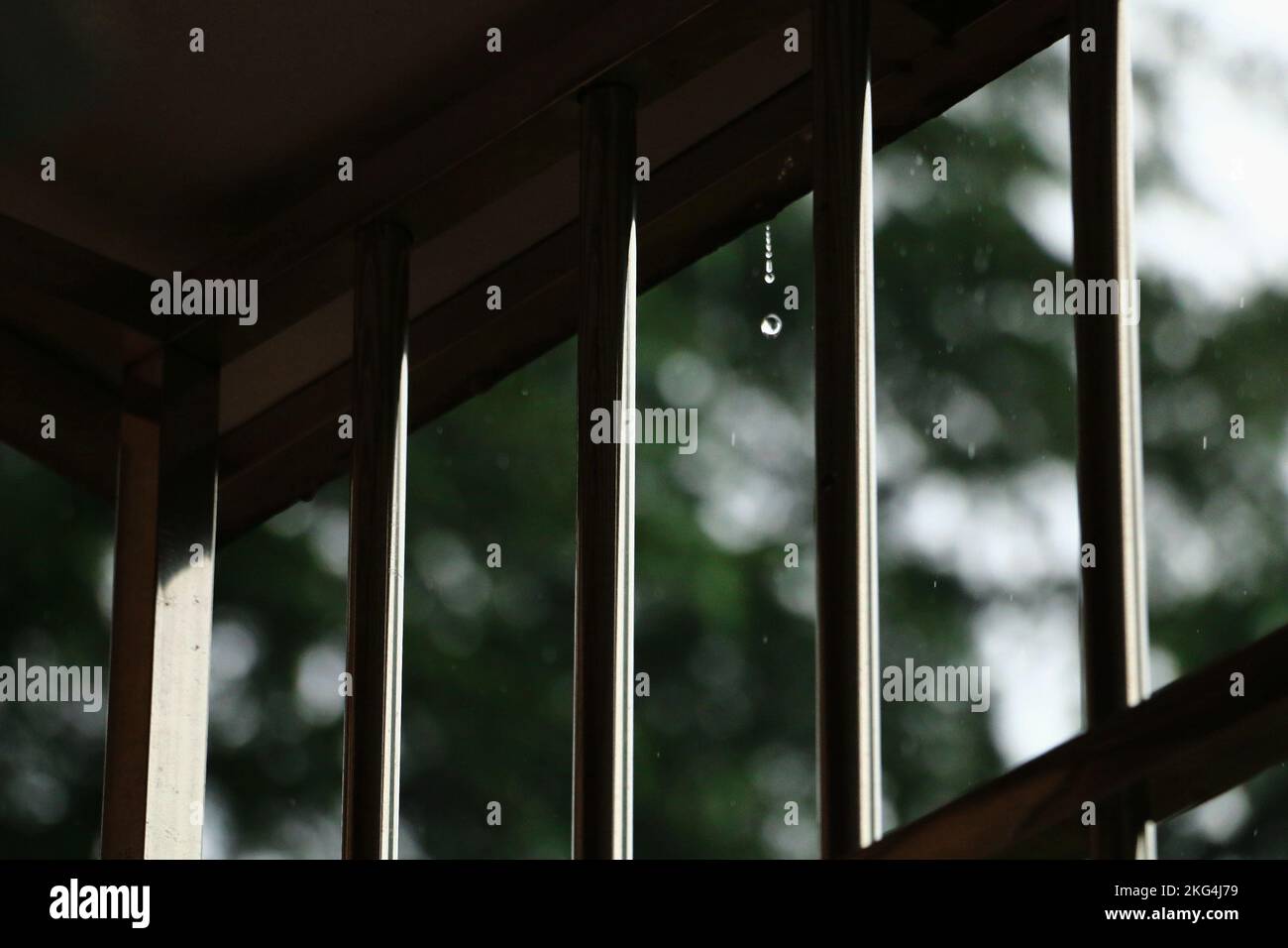 A close-up shot of a raindrop falling from a rooftop Stock Photo - Alamy
