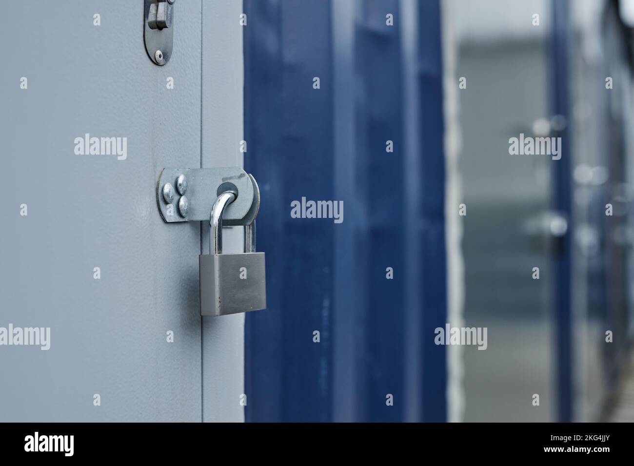Closeup of metal lock on door of containers in shipping dock, copy ...