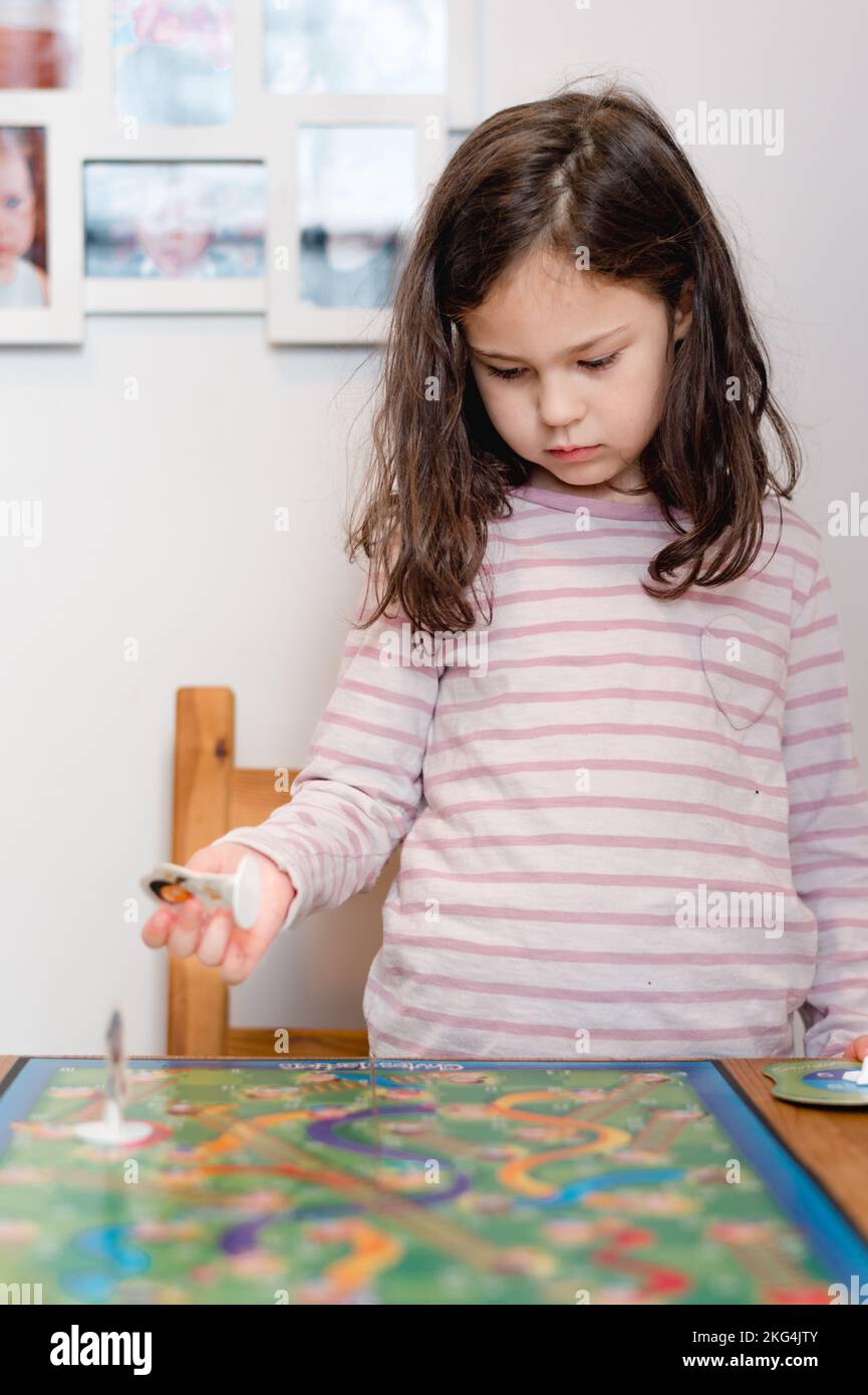 young pretty girl playing a board game at home in the kitchen Stock ...