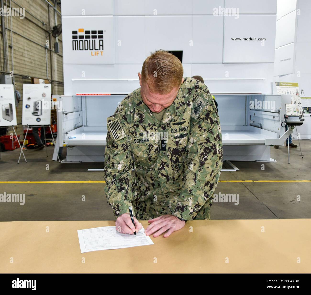 Capt. Cory Schemm, commanding officer NAVSUP FLC San Diego, signs the ...