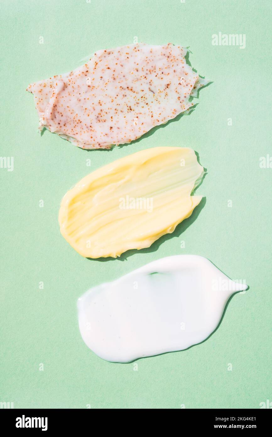 Cream and scrub smears texture. Set of cosmetic products smudges over ...