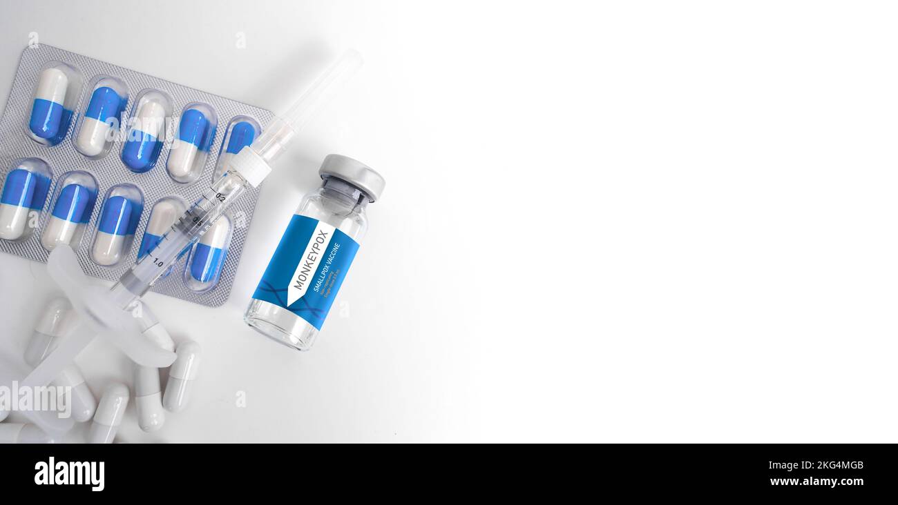 Monkeypox and smallpox vaccine vial with a medical syringe and tablet ...