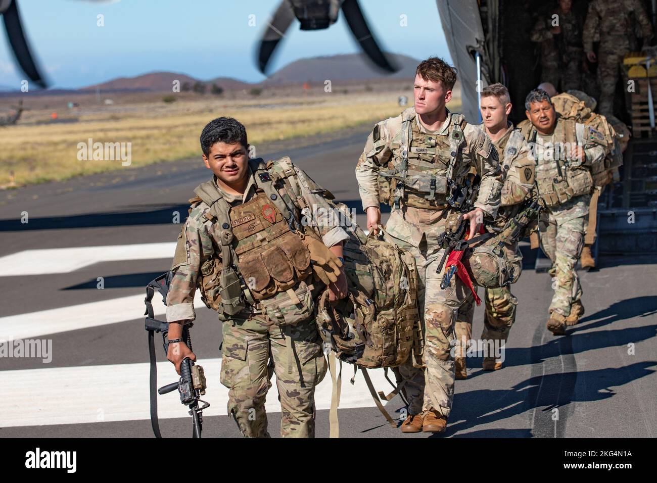 Soldiers from the 25th Infantry Division, exit a C-130, at Pohakuloa ...