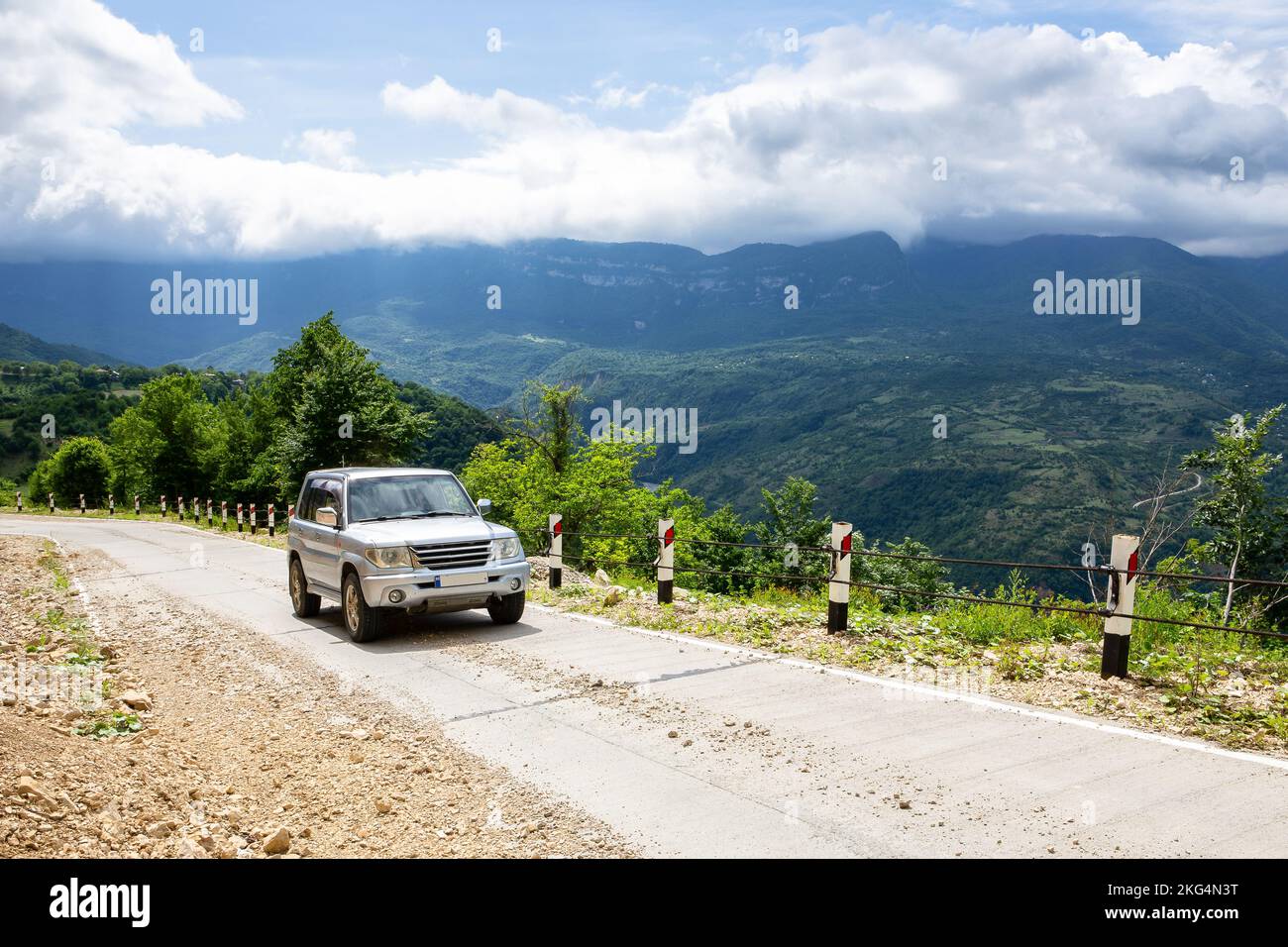 4x4 off-road car driving on a gravel road uphill towards Khvamli ...