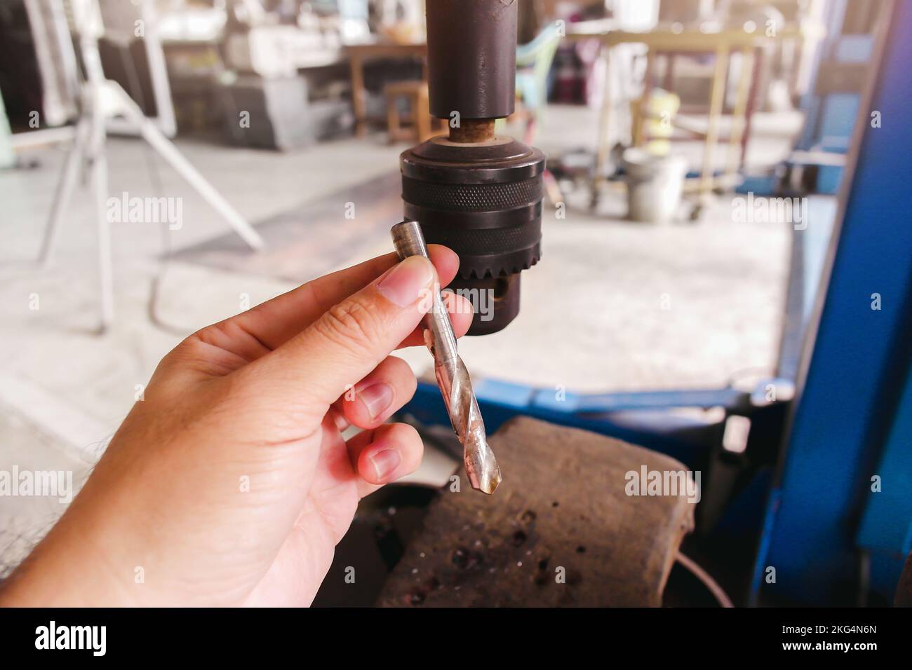 Metal drill bit for drill press machine holding on mechanic hand in the ...