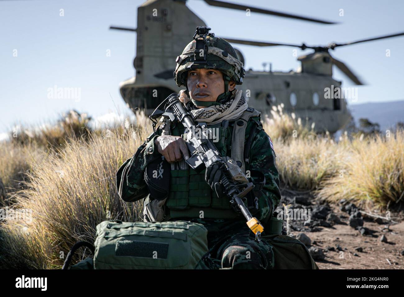 A Royal Thai Armed Forces member pulls security after landing and ...