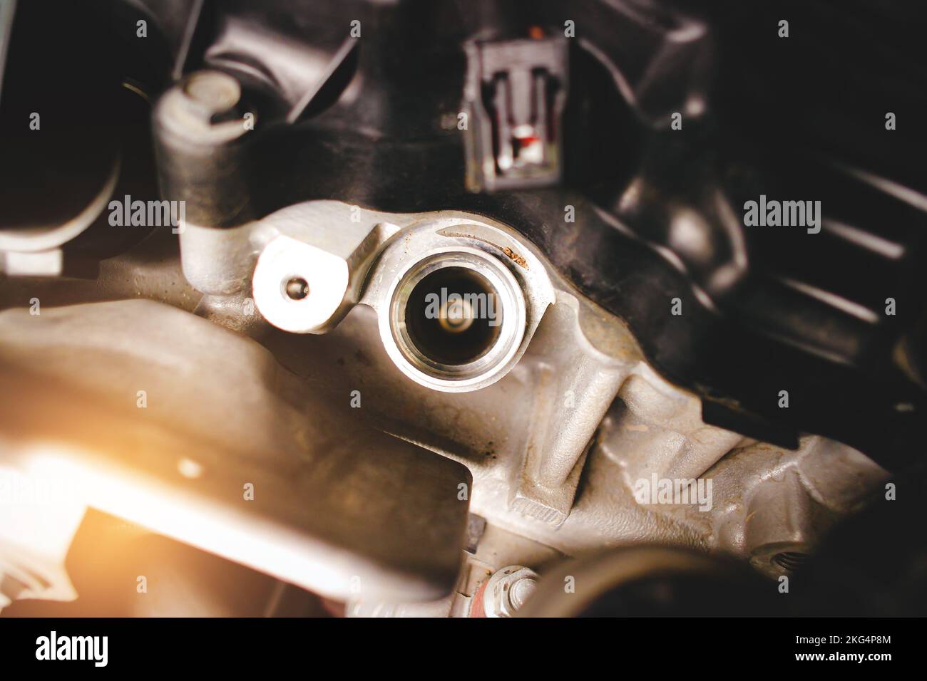 The spark plug socket of a car engine without an ignition coil in the ...