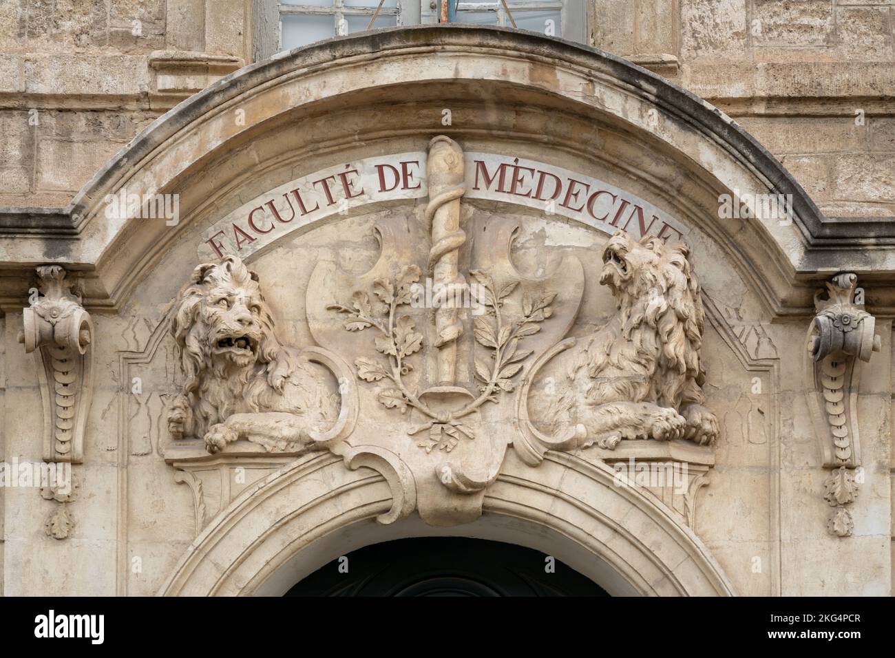 View of ancient carved stone pediment with caduceus and lions above ...