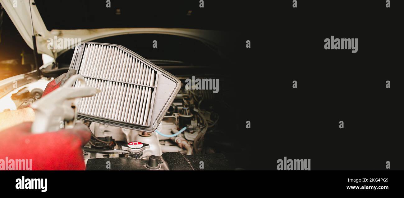 Car air filter cleaning with air blow gun by auto mechanic hand in the ...