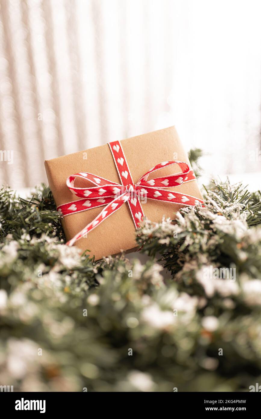 Kraft cardboard gift box tied with rough jute rope on gray wooden ...