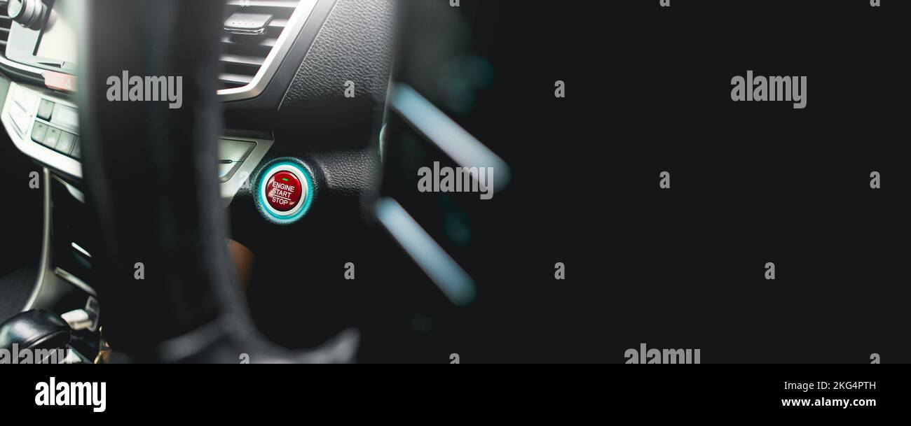 Red engine start stop button with an LED blue light on panel in a ...