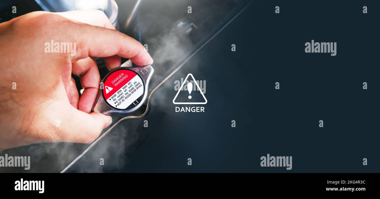 The mechanic hand was holding onto the car hot radiator cap with the ...