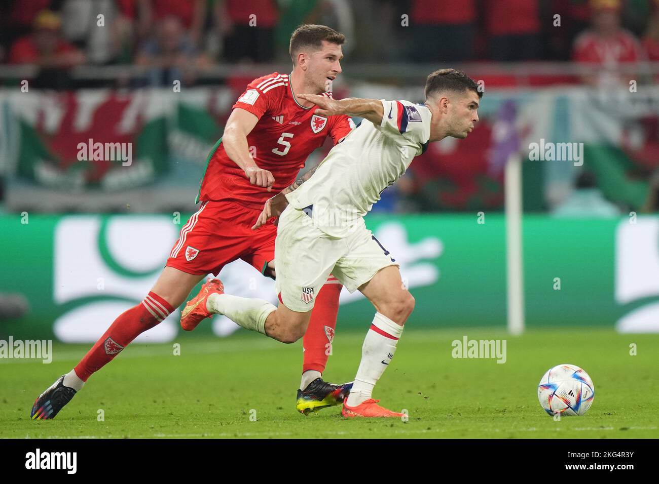 Chris Mephan of Wales and Christian Pulisic of USA during the Qatar ...