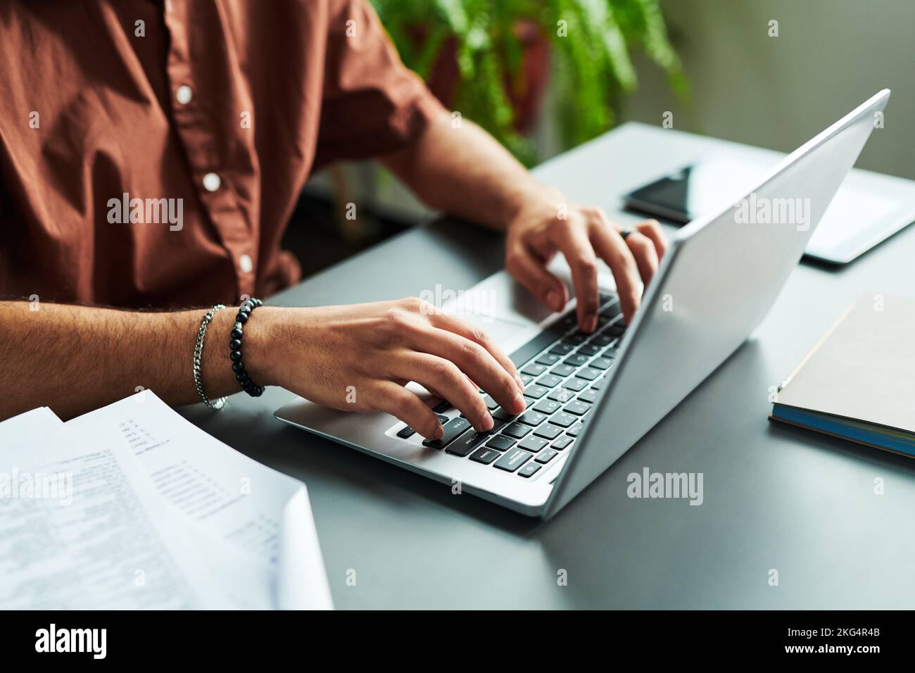 Close-up of hands of young student typing on laptop keyboard while ...