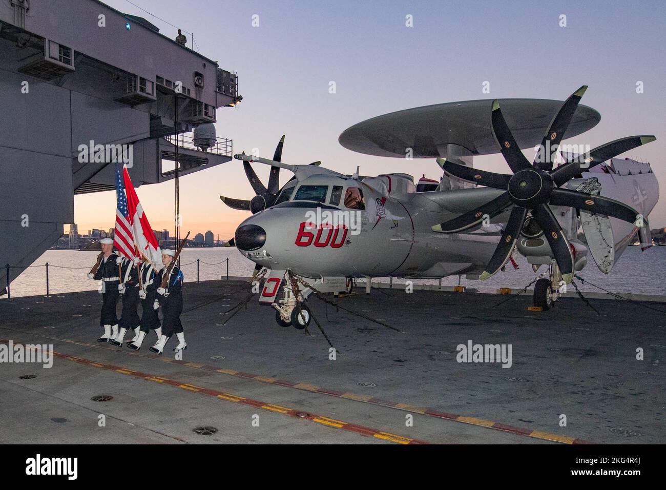 A ceremonial color guard marches into the hangar bay of the first-in ...
