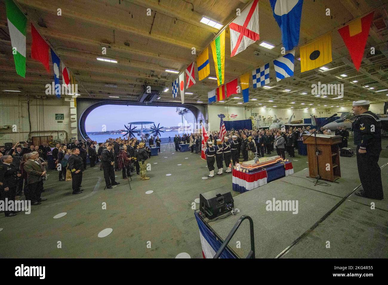 A ceremonial color guard presents colors inside the hangar bay of the ...