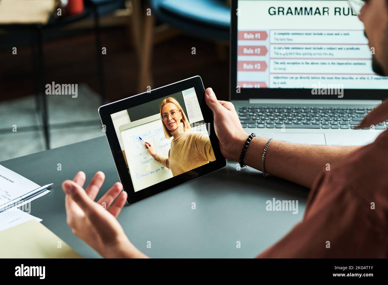 Confident blond tutor presenting new English grammar subject at lesson ...