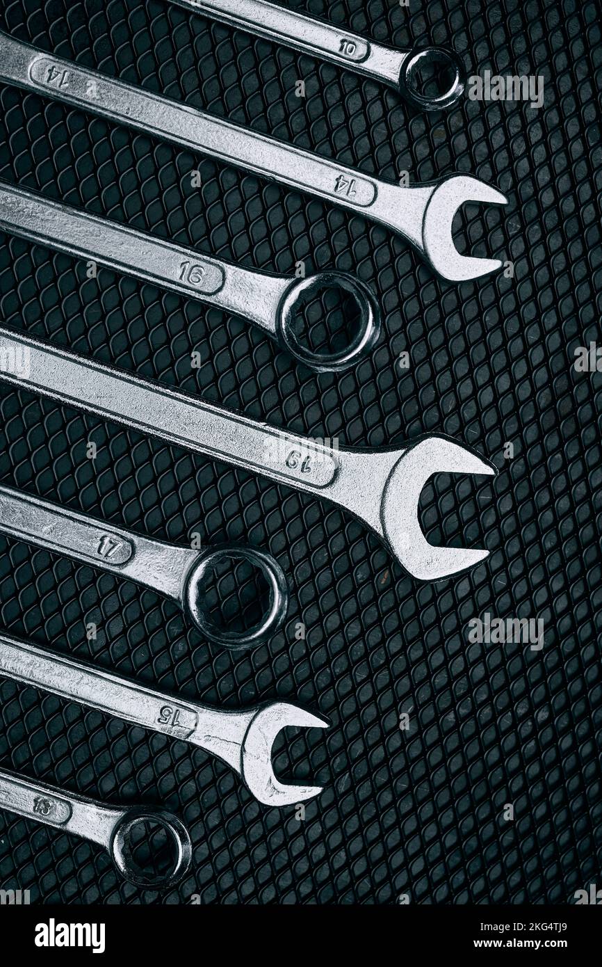 Set of chrome wrenches on steel surface. Mechanic tools for maintenance ...