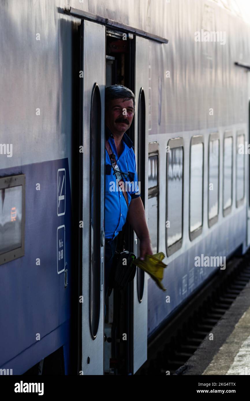 Railworker, train staff signaling for train conductor in Bucharest ...