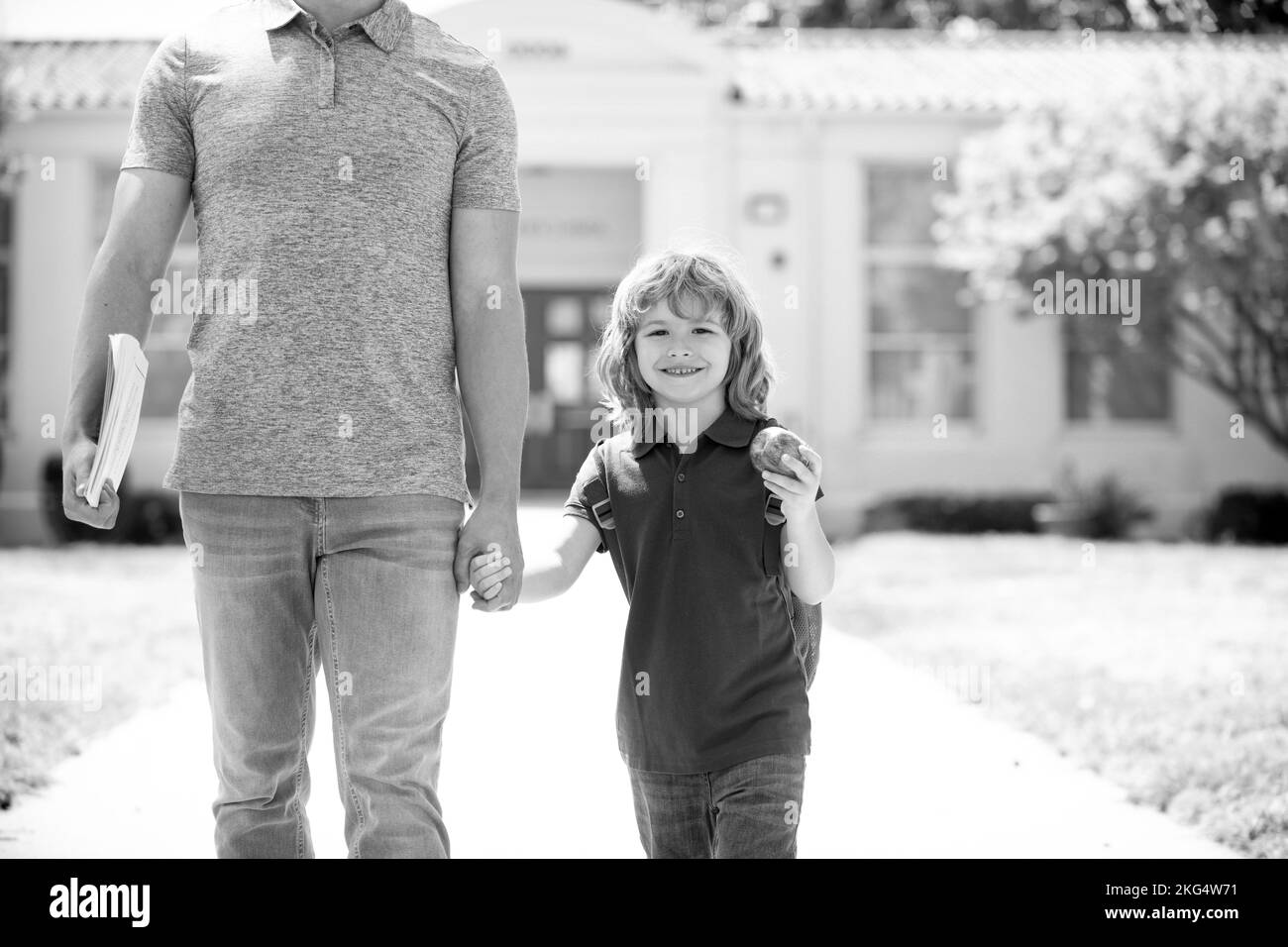 childhood and parenthood. cropped parent leads child boy in first grade ...