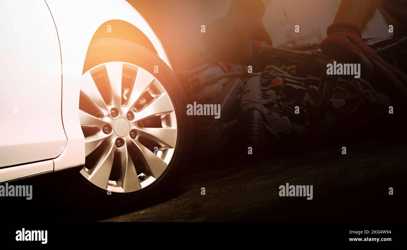 Alloy wheels of the white car are turning on the cement road and engine ...