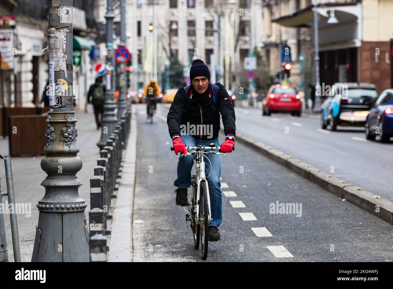 Riding a bicycle on the city streets. Commute to work in Bucharest ...