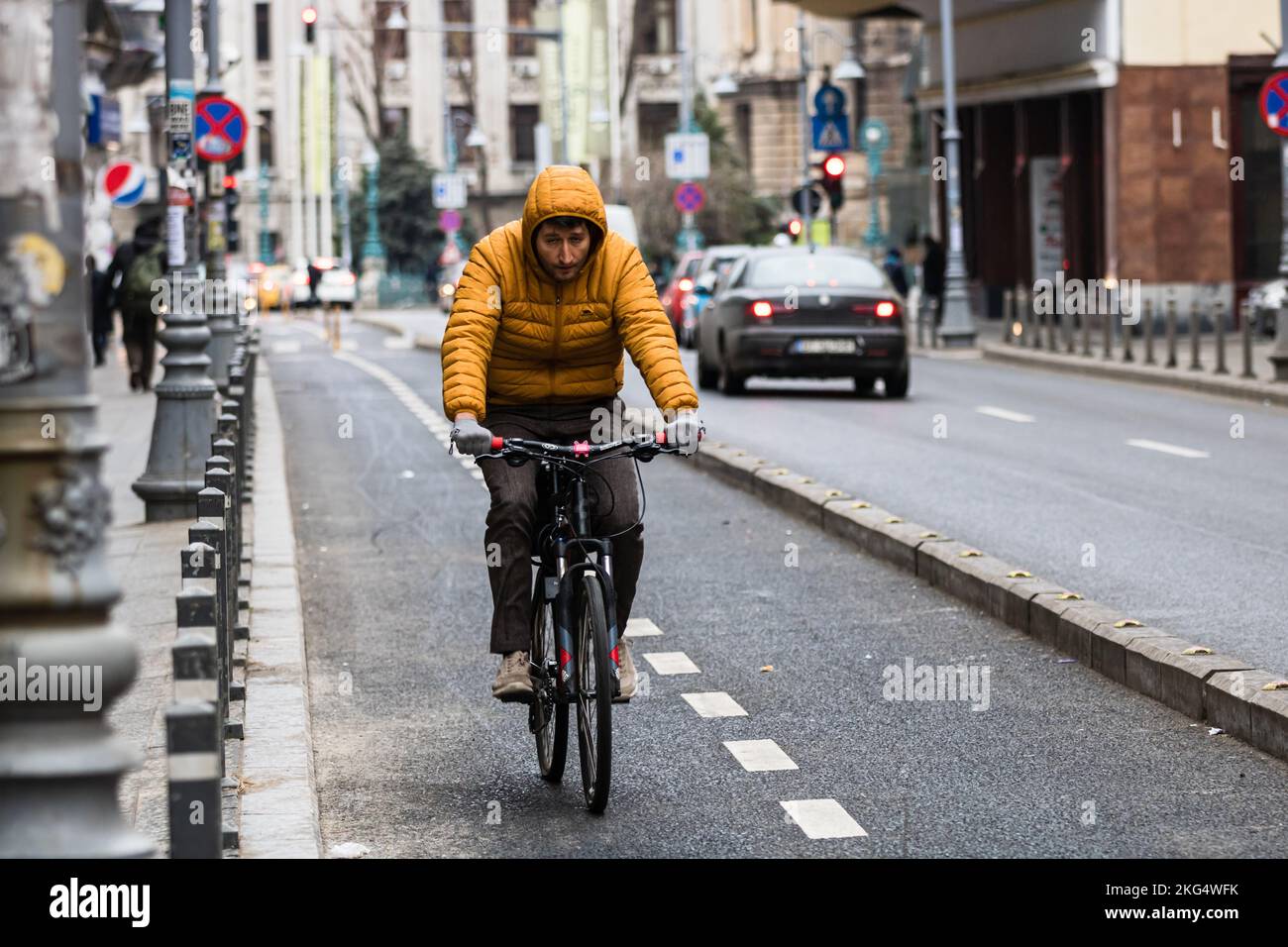 Riding a bicycle on the city streets. Commute to work in Bucharest ...