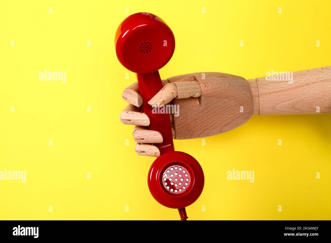 Wooden hand holding a red old fashioned retro telephone handset Stock ...
