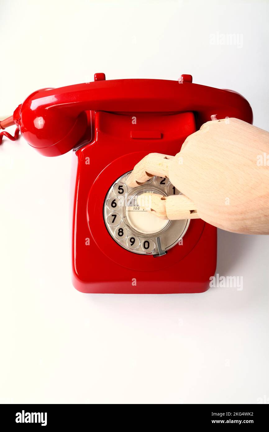 Wooden hand using a vintage retro old red dial telephone Stock Photo ...