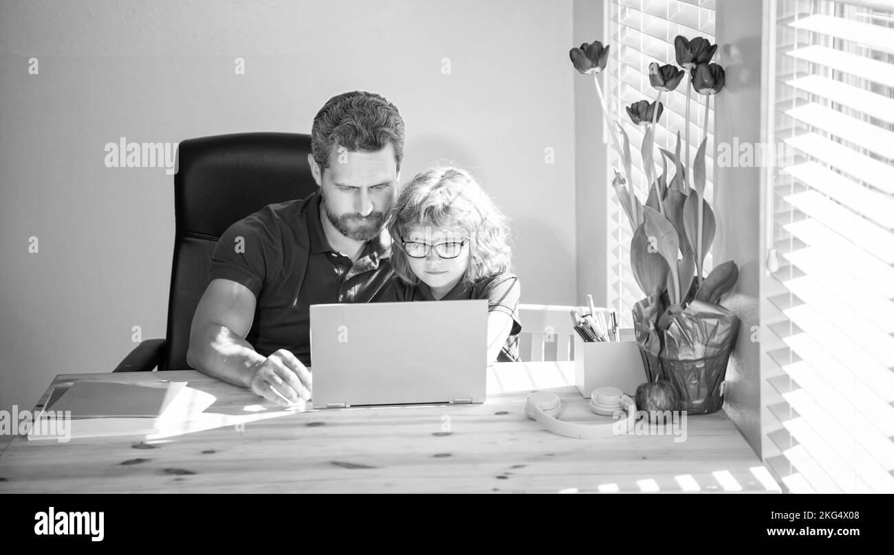 concentrated father and son in glasses use computer. family blog. nerd ...