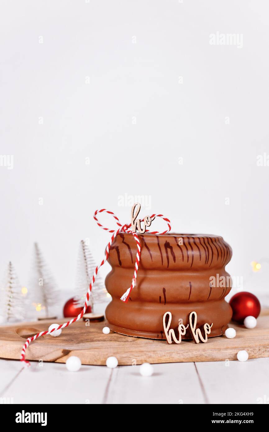 Layered spit cake called 'Baumkuchen' glazed with chocolate in front of ...