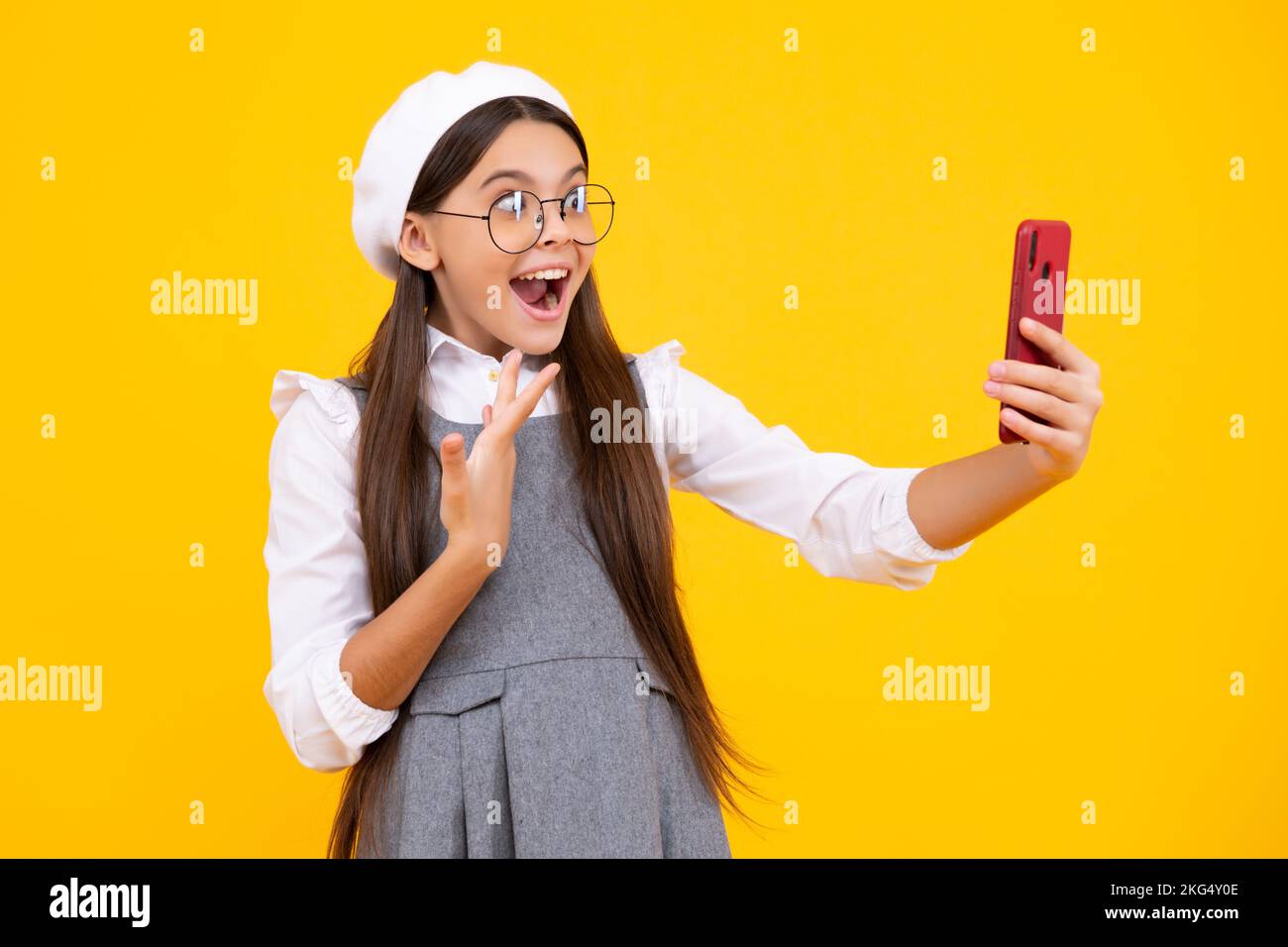 Kids selfie. Portrait of cute teenage girl using mobile phone, chatting ...