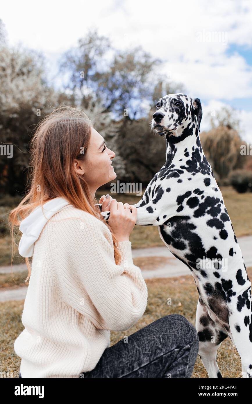 girl with a dalmatian dog in nature Stock Photo - Alamy