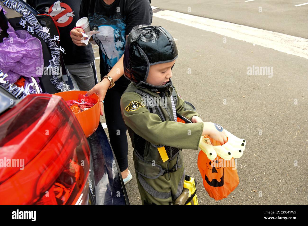 A child puts candy inside his bag during a Trunk or Treat event at ...
