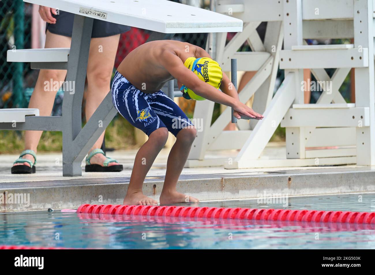 A swimmer prepares to dive into a pool during a Guam Swimming ...