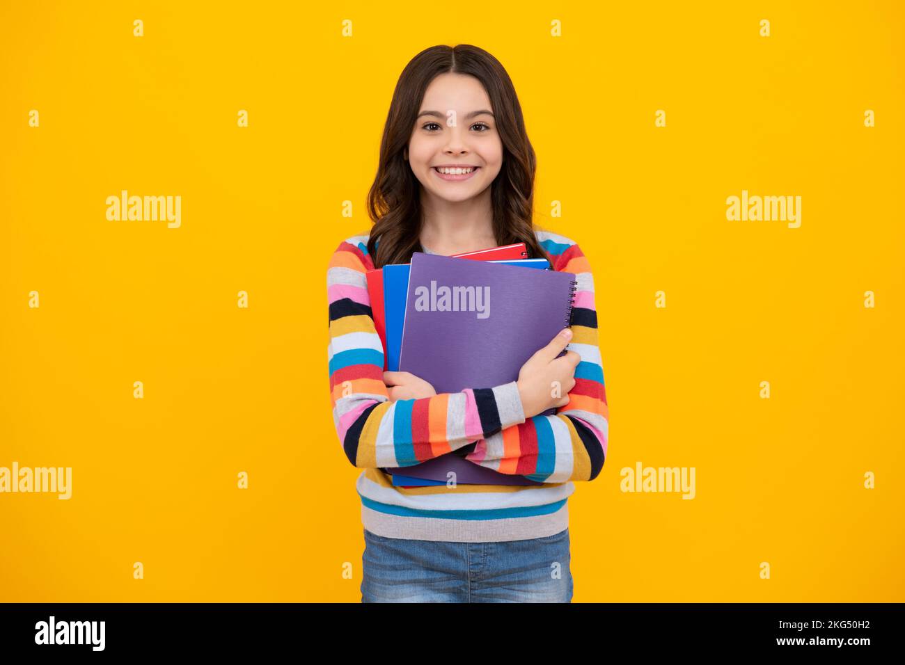Teen girl pupil hold books, notebooks, isolated on yellow background ...