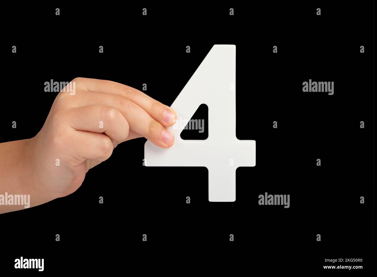 Number four in hand isolated on black background. Number four in a ...