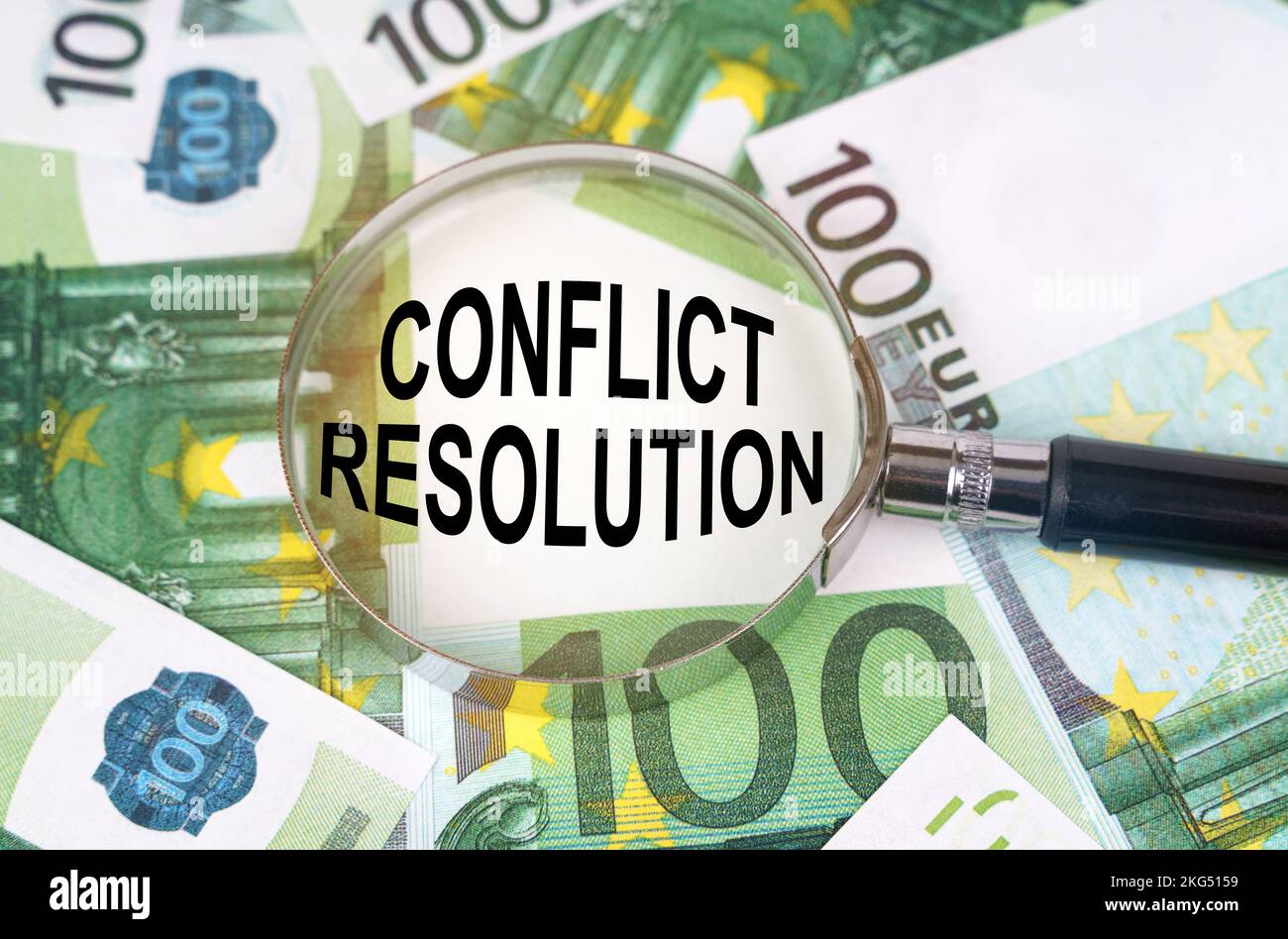 Business concept. Among the euro banknotes is a magnifying glass with ...