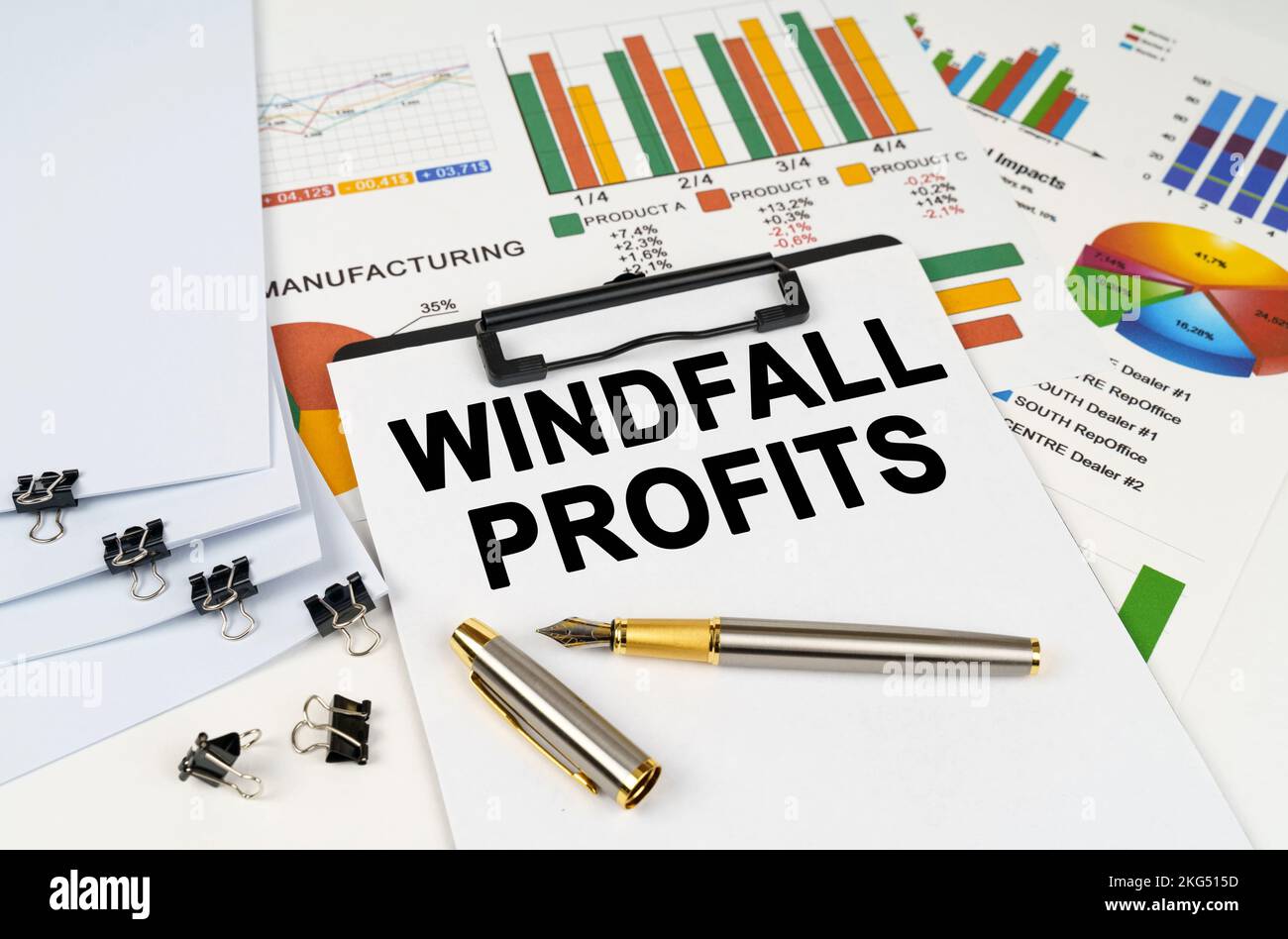 Business concept. On the table among financial graphs and charts lies a ...