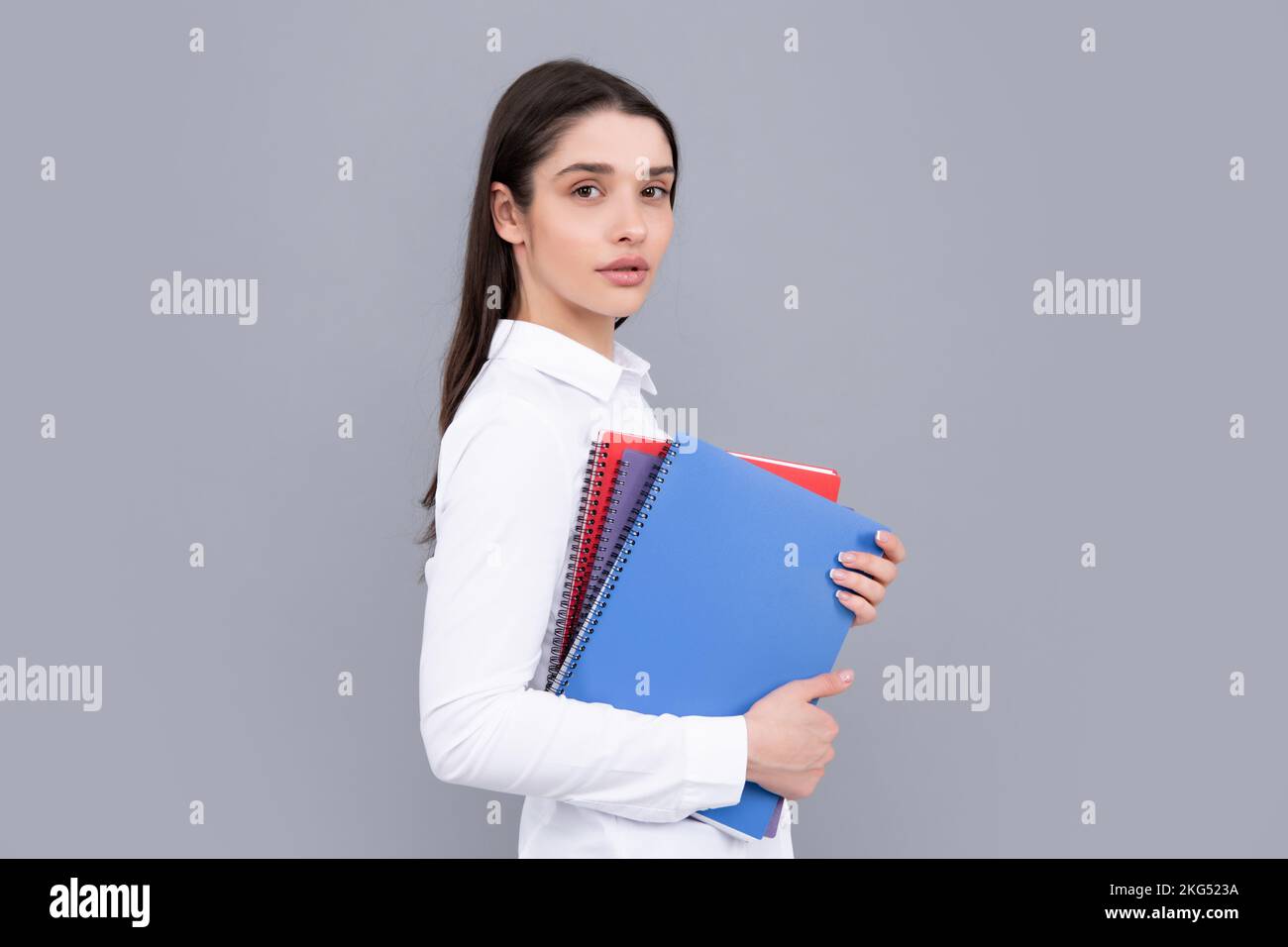 Charming student isolated on gray background. Woman high school student ...