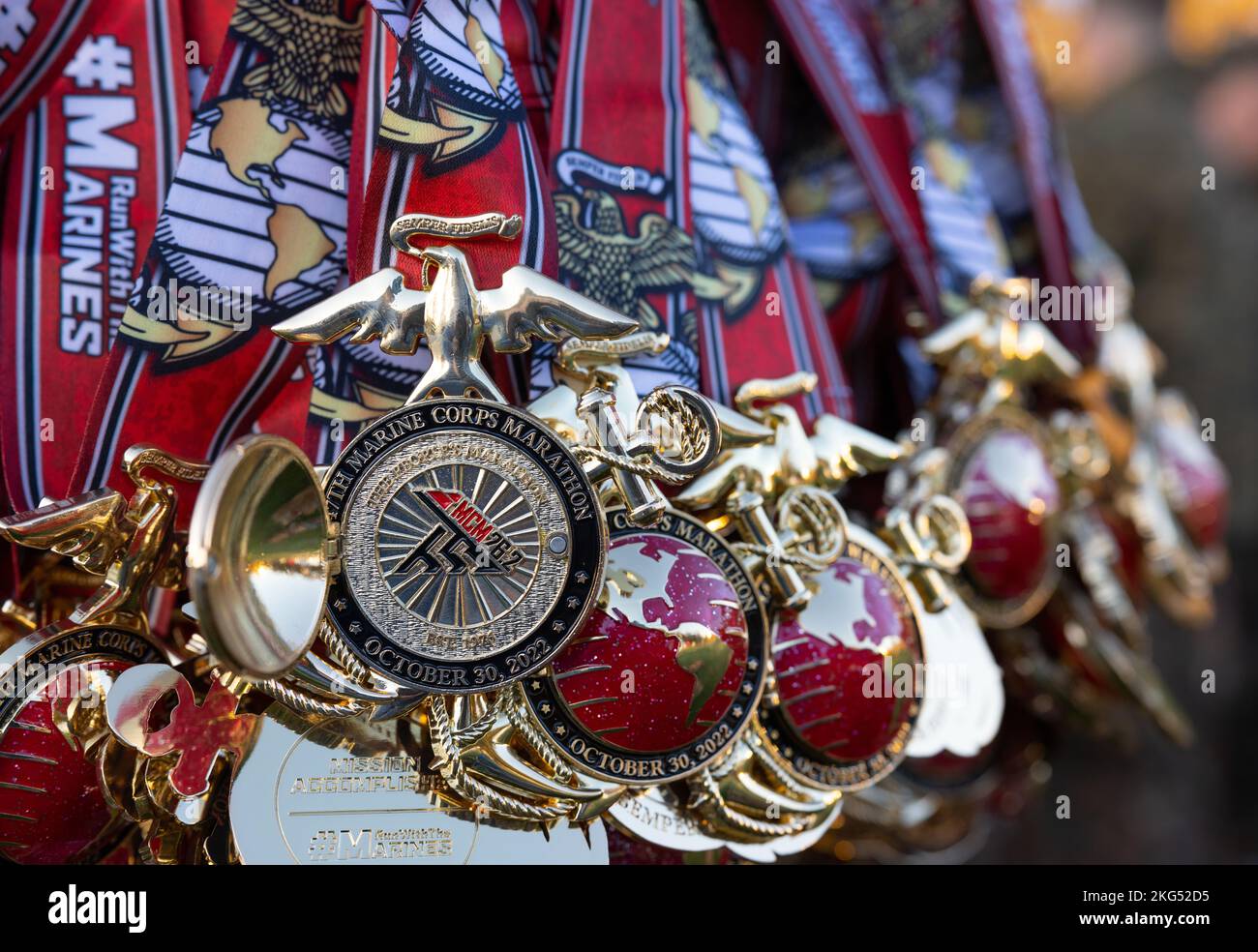 Runners of the 47th Marine Corps Marathon receive a medal once they ...